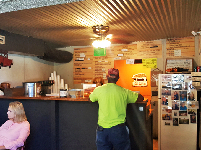 The corrugated metal ceiling and wood-paneled walls create that perfect "we care about the food, not the frills" atmosphere that serious barbecue demands.