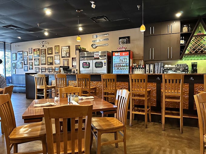 The bar area isn't just functional &ndash; it's a front-row seat to the culinary show. Those wooden chairs have heard all the best food moans.