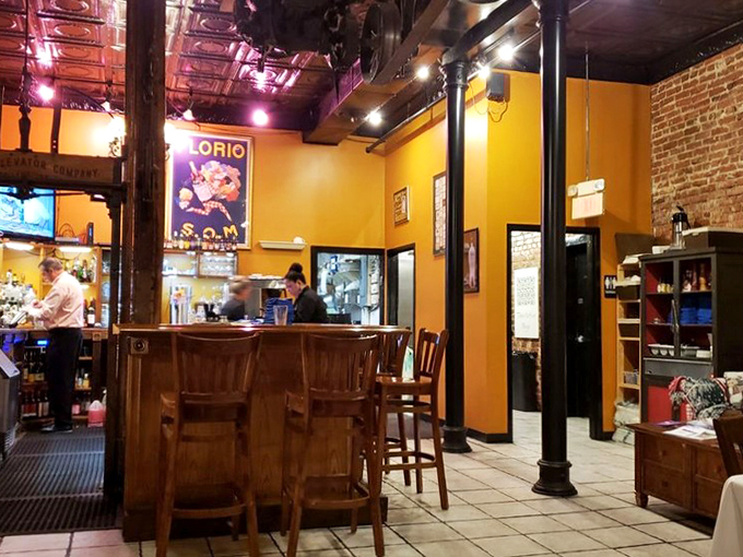 The bar area's sunny yellow walls and vintage posters create the perfect backdrop for pre-dinner drinks or post-work unwinding. Somewhere Hemingway is nodding in approval.