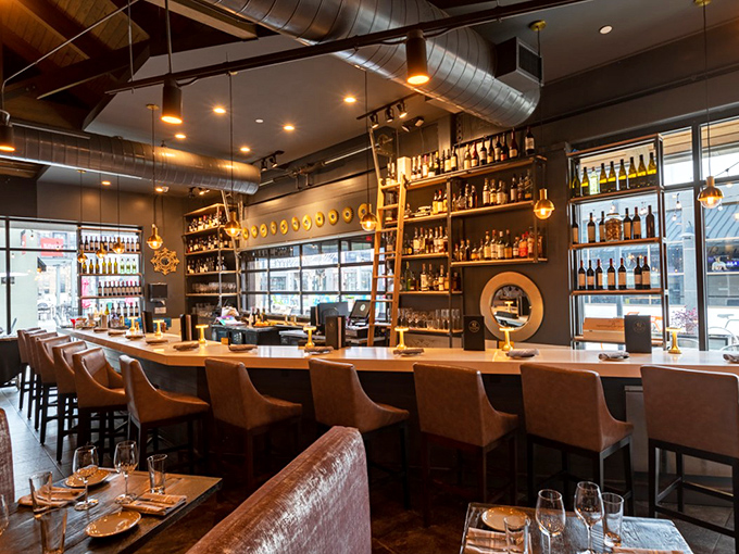 The bar beckons like an old friend with stories to tell. That rolling ladder isn't just practical&mdash;it's a promise of spirits worth climbing for.