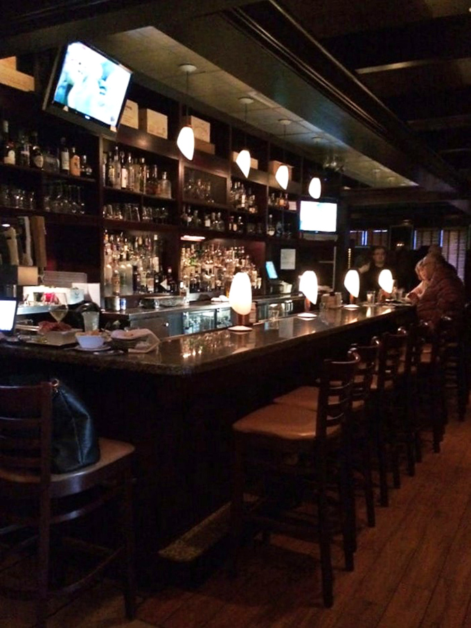 At this bar, bottles line up like soldiers ready for duty, each waiting for their chance to transform an ordinary evening into something memorable.