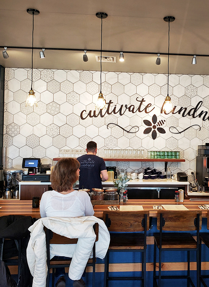 Cultivate kindness &ndash; both a lovely sentiment and solid advice when waiting for your coffee. The honeycomb tile backdrop adds visual interest without overwhelming the space.