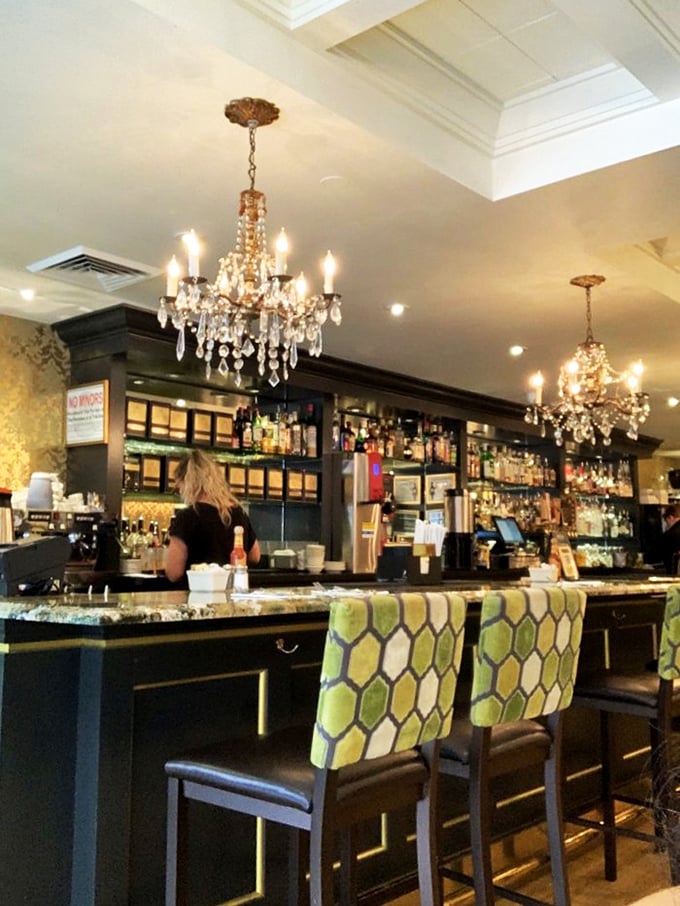 The bar area whispers "stay awhile" with crystal chandeliers above and comfortable seating below. Brunch cocktails never had a more elegant home. 
