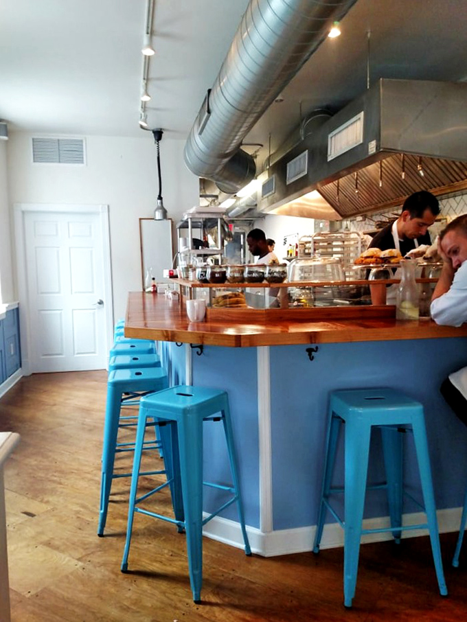 The breakfast bar &ndash; where kitchen theater meets morning sustenance. Those blue stools have witnessed countless first bites of Dutch Baby bliss.