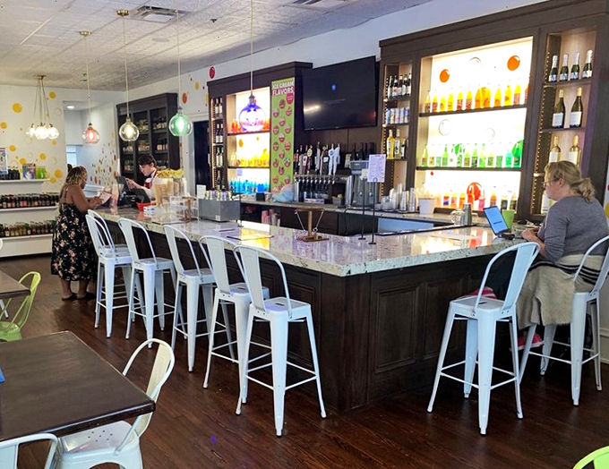 The grown-up corner of candy paradise, where craft cocktails meet sweet inspirations under the glow of colorful pendant lights.