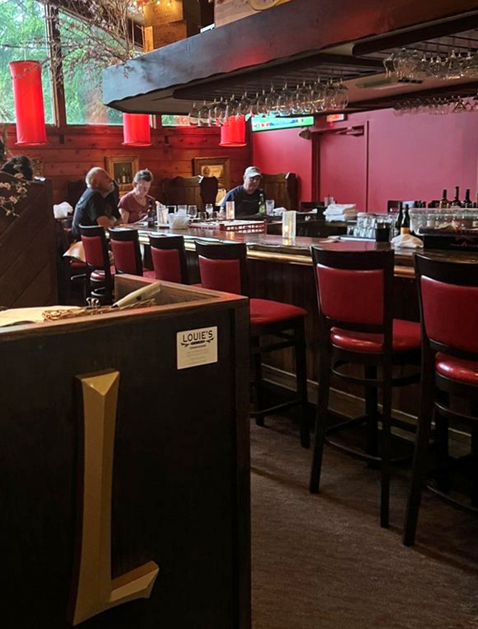 The bar – where cocktail craftsmanship meets woodland charm, and strangers become friends over shared appreciation of liquid artistry.