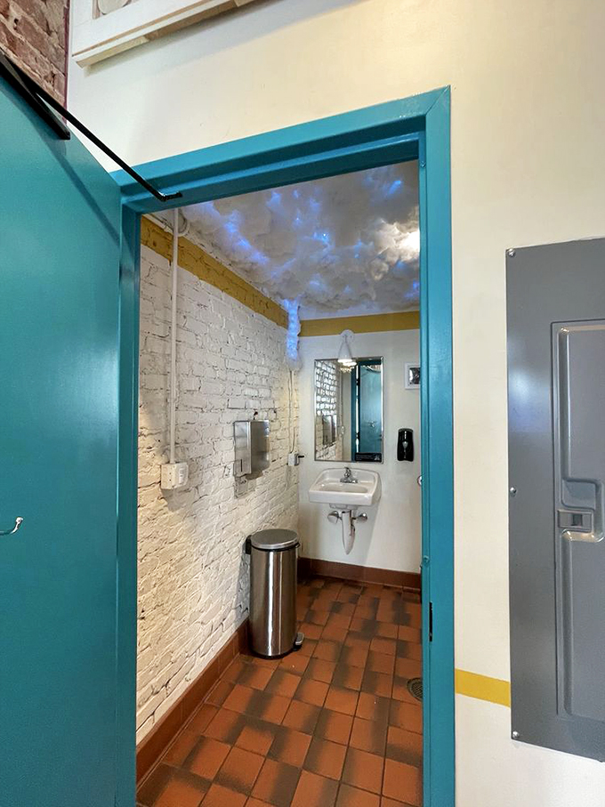 Even the bathroom at How Crispy Express gets the design treatment with exposed brick and a cloud-painted ceiling.