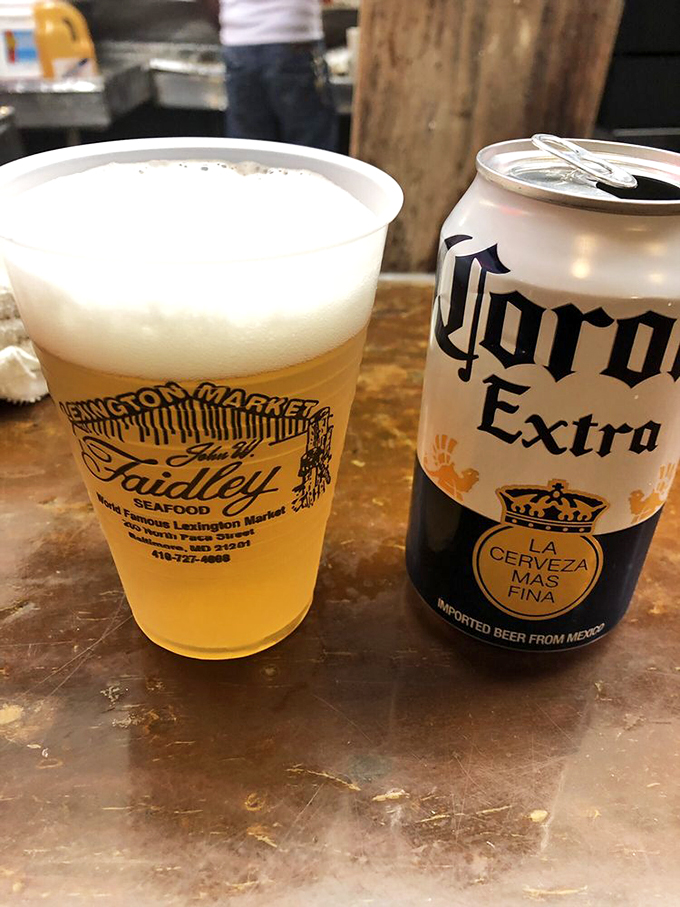 The perfect pairing: a cold Corona and a plastic cup bearing the Faidley name&mdash;sometimes simple pleasures are the most profound.