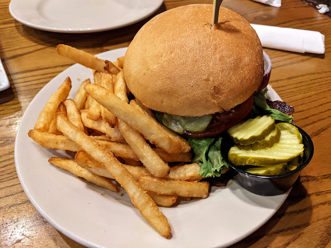 A burger that stands tall and proud, with a golden dome of a bun that's practically begging you to compress it for that first magnificent bite.