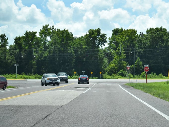 Modern life briefly interrupts the timelessness of Highway 62. Even stop signs seem more contemplative against this verdant backdrop.