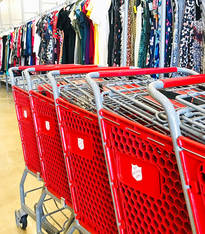The iconic red shopping carts stand ready for filling, their Salvation Army shields a reminder that today's bargain hunting supports tomorrow's community services.