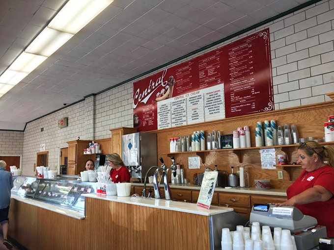 Behind this counter, ice cream alchemists transform simple ingredients into memories. The red menu board is their periodic table.