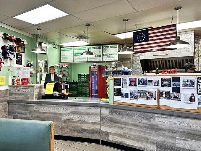 Behind this counter, burger magic happens. The green walls and patriotic decor remind you this is America's comfort food at its finest.