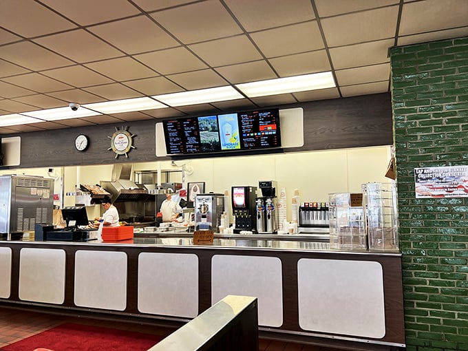 Behind this counter, burger artisans perform their daily ritual, transforming humble ingredients into edible memories since before your grandparents' first date.