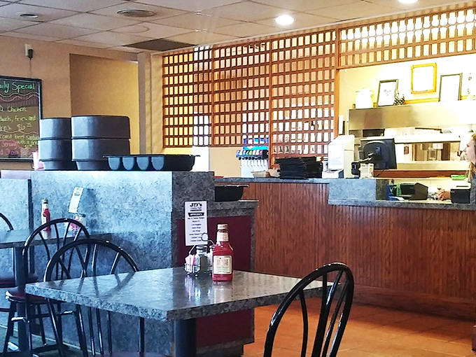 Behind that wooden lattice divider, chicken magic happens daily. The counter view offers a glimpse into the heart of this beloved establishment.