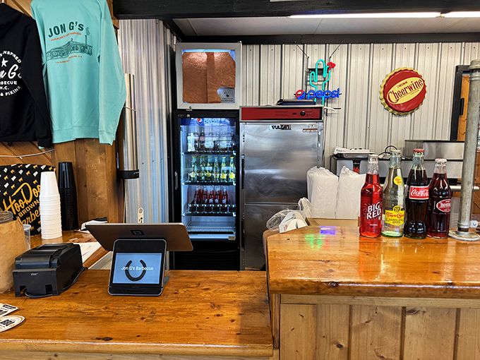 Behind this simple wooden counter, BBQ magic happens with the efficiency of a well-rehearsed ballet and the warmth of Southern hospitality.