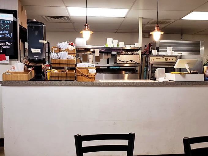 Behind this counter, culinary magic happens daily. The workspace may be humble, but the results are extraordinary.