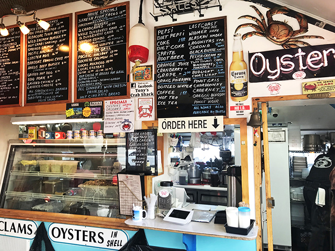 The ordering counter—where seafood dreams begin their journey to reality. Blackboards showcase the day's offerings like a culinary theater marquee announcing the stars.
