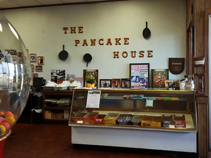 The counter area showcases decades of breakfast wisdom, with cast iron pans hanging like medals of honor earned in countless breakfast battles.