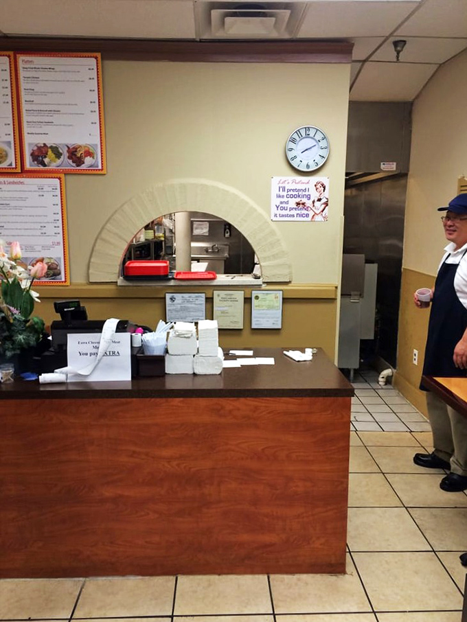 The pass-through window&mdash;where kitchen magic becomes plate reality. That sign promising "I'll pretend I like cooking, you pretend it tastes nice" is delightfully unnecessary here.