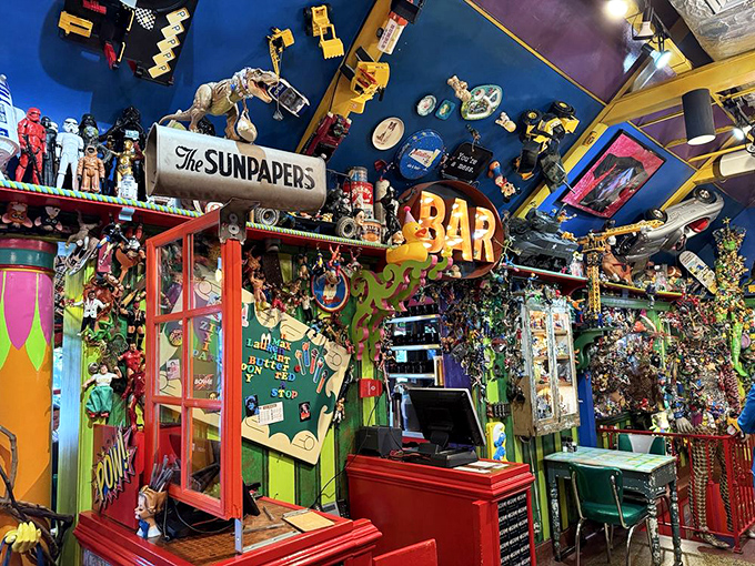 The "NICE" sign above the counter isn't just decor—it's truth in advertising. Every inch of wall and ceiling space hosts a toy reunion party.