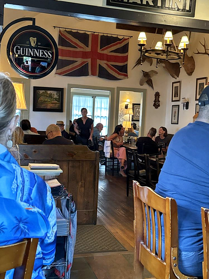The dining room buzzes with conversation and clinking glasses as patrons enjoy a proper British dining experience. Everyone looks happier with a pint in hand.