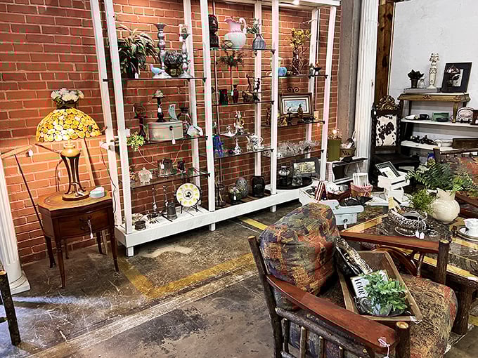 Exposed brick walls and original factory windows create the perfect gallery-like backdrop for this thoughtfully arranged collection of vintage furnishings.