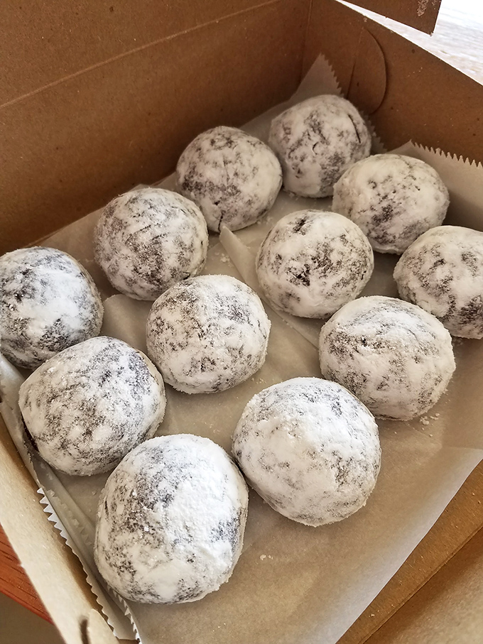 Powdered donut holes &ndash; the perfect bite-sized morsels of joy that somehow always leave evidence on your shirt.