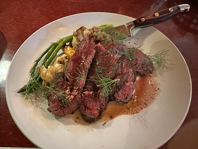 Elk loin that would make any hunter weep with joy. The delicate garnish of fresh dill adds a touch of elegance to this primal feast.