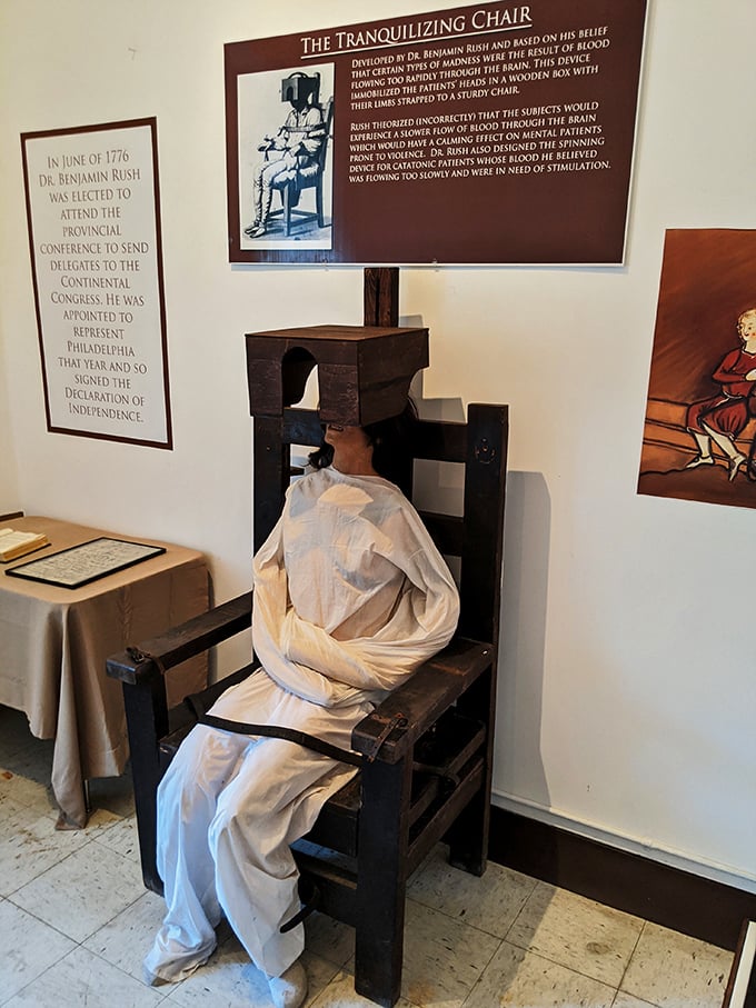 A graceful staircase curves upward, its polished banister and framed photographs suggesting the administrative areas were worlds apart from patient quarters.