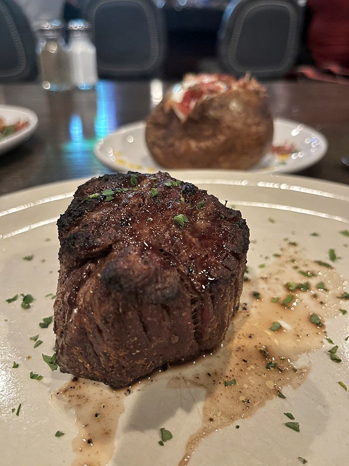 A filet mignon so perfectly seared it looks like it graduated from Harvard. That jus pooling around it is basically liquid gold.