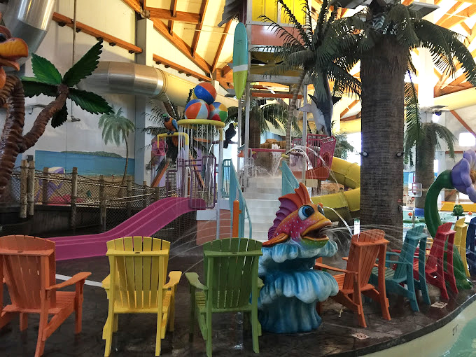 Whimsical tropical sculptures and rainbow chairs create a Dr. Seuss-meets-Jimmy Buffett vibe that somehow works perfectly in landlocked Kansas.