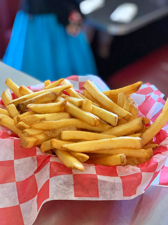 French fries served in checkered paper&mdash;simple perfection that reminds us why sometimes the classics need absolutely no improvement.