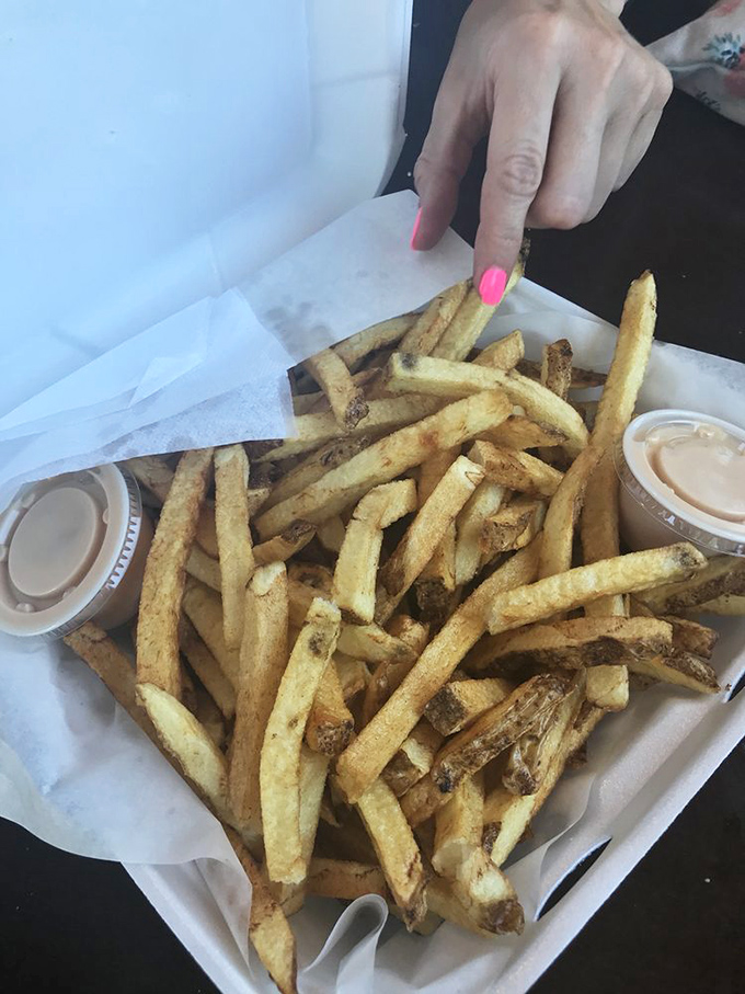 French fries so perfectly golden they deserve their own trophy. Two dipping sauces because life's too short to commit to just one flavor adventure.
