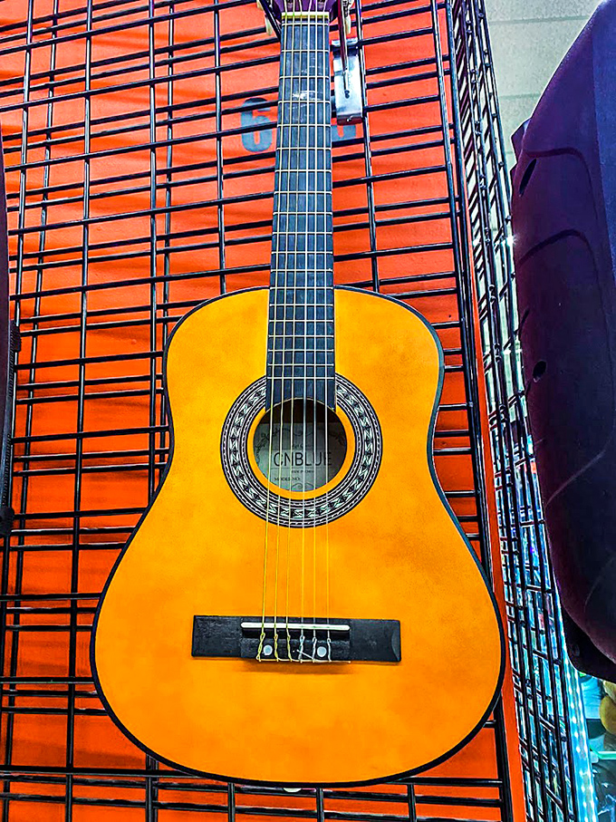 Six strings of possibility hanging on display, waiting for someone's fingers to transform them into stories, songs, and Saturday night serenades.