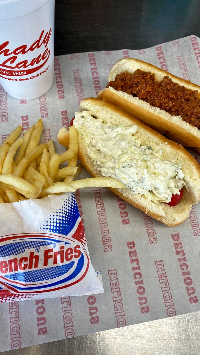 The holy trinity of drive-in perfection: crispy fries, heavenly slaw dog, and chili dog that dreams are made of.