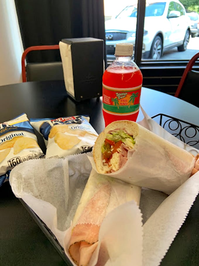 The complete meal deal &ndash; sandwich, chips, and vibrant fruit drink create the lunch trifecta that makes afternoon meetings bearable.