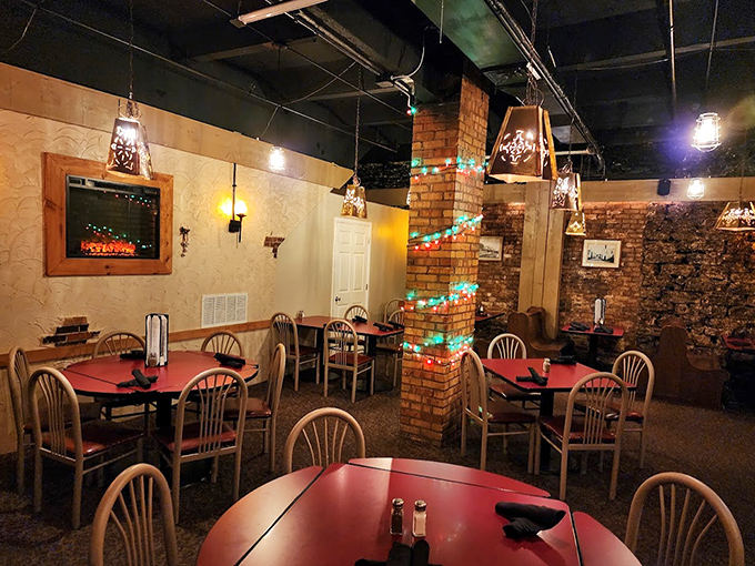 Red tables, brick columns, and twinkling lights create the kind of ambiance you can't manufacture. Comfort wrapped in casual elegance.