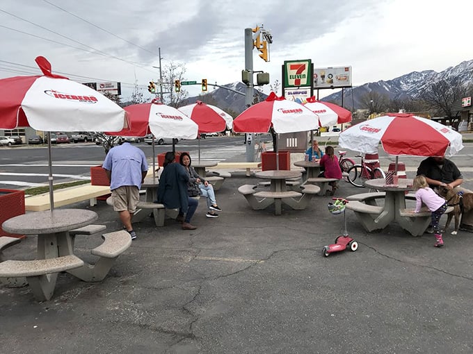 Outdoor seating with a view of the Wasatch Mountains makes every meal feel like a mini vacation, red and white umbrellas included.