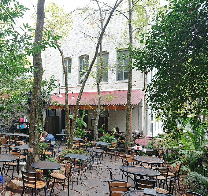 Nature and nurture combine in this magical outdoor seating area&mdash;dappled sunlight filtering through trees while tables await your food adventure.