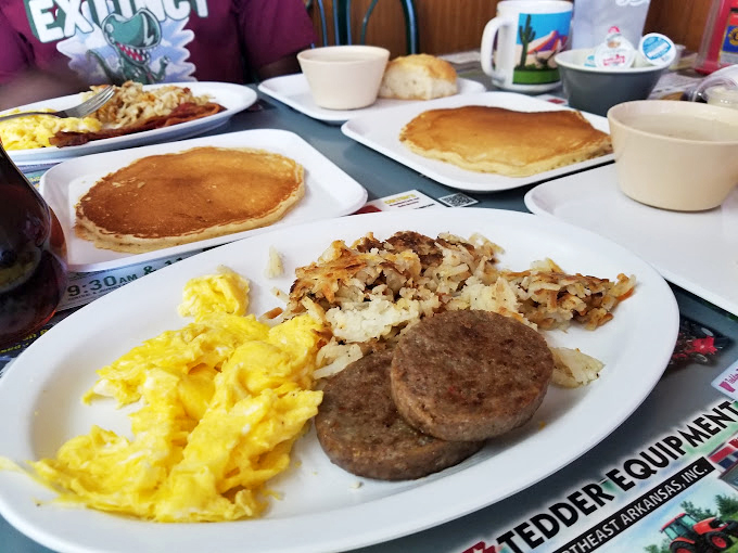 Breakfast of champions &ndash; golden pancakes, scrambled eggs, and sausage patties that make you understand why morning people are so annoyingly cheerful. P