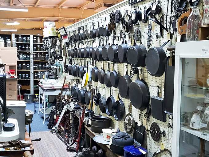 Cast iron paradise where kitchen workhorses hang in formation. These pans have probably flipped more pancakes than all IHOP locations combined.