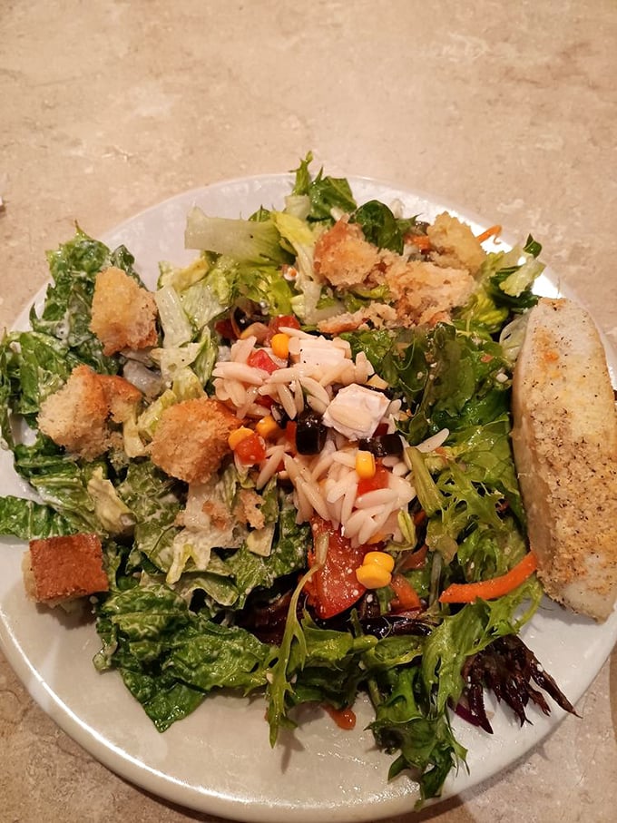 A salad that's trying its best to be virtuous while surrounded by croutons plotting its downfall.