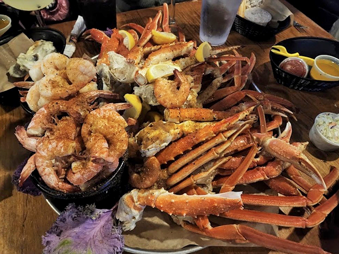 The seafood board that launched a thousand food cravings - crab legs sprawled out like they're sunbathing on a wooden beach.