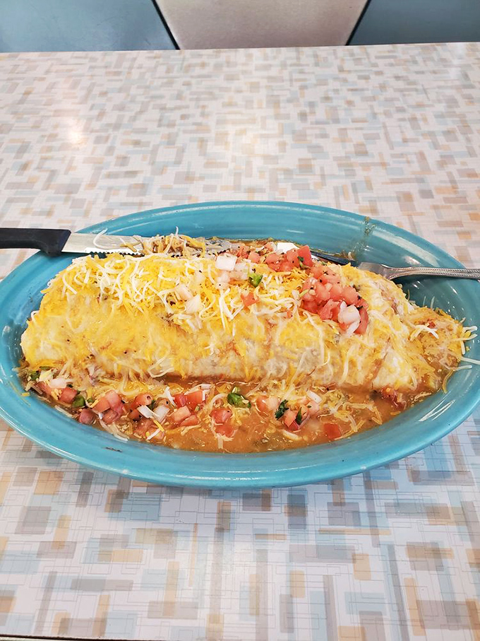 A burrito that doesn't know the meaning of modesty, blanketed in melted cheese and fresh salsa. This isn't just breakfast&mdash;it's edible morning motivation.