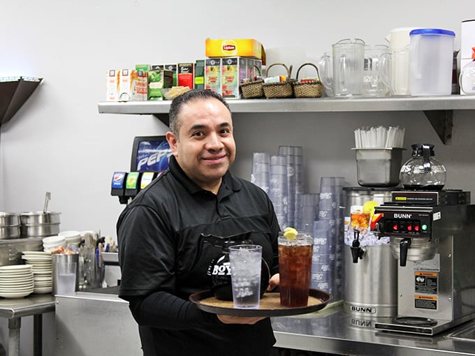 Behind every great restaurant is someone who treats your order like it matters. That smile says your pie selection is in good hands.