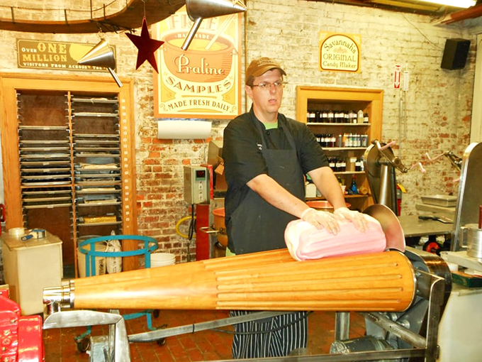 A candy artisan works his magic on the taffy pull, transforming simple ingredients into stretched perfection. This is edible performance art at its finest.