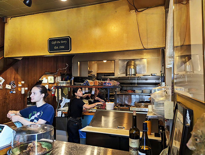 Behind the counter, culinary wizards transform simple ingredients into morning masterpieces with the efficiency of seasoned breakfast veterans. 