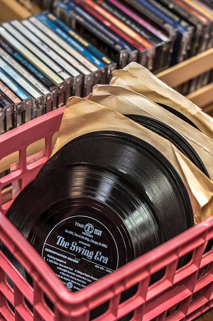 Vinyl records nestled in their sleeves like time capsules of sound. The Swing Era album is practically begging you to host a cocktail party.