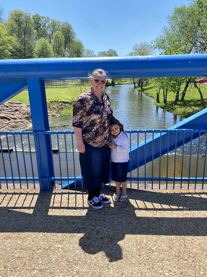 The blue bridge offers a moment of tranquility before the adrenaline rush. Some memories are made on go-karts, others in these quiet moments together.